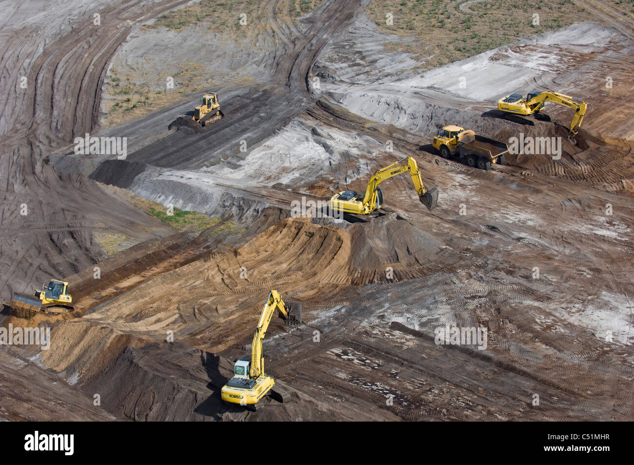 Earth moving construction equipment moving dirt Stock Photo - Alamy