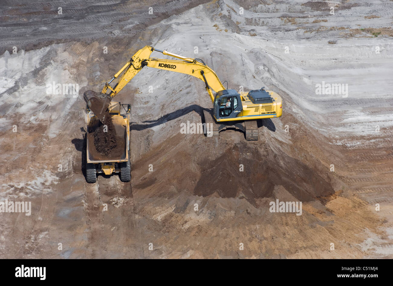 Earth moving construction equipment moving dirt Stock Photo - Alamy