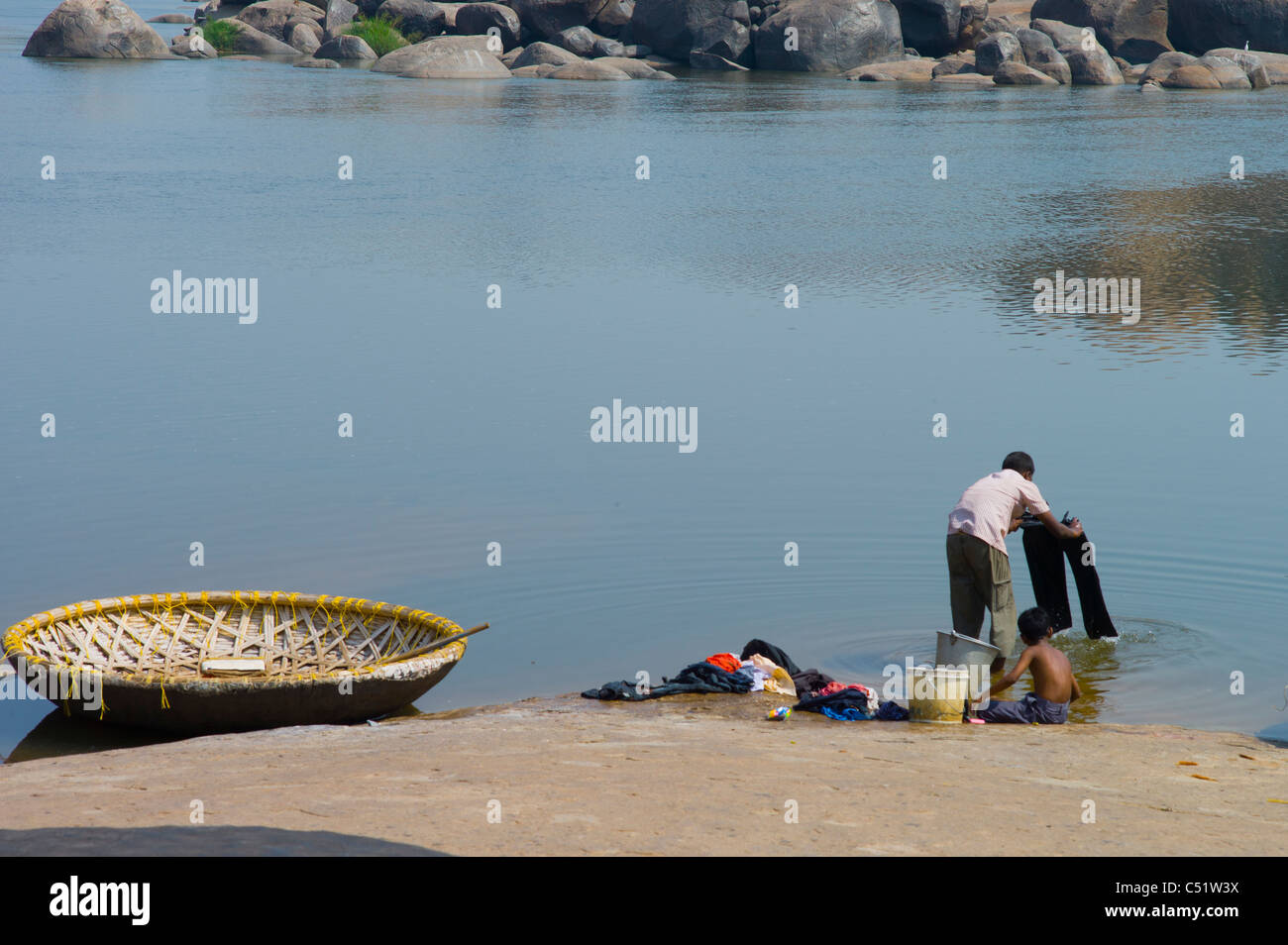 A man washing clothes in the Tungabhadra river in Hampi, Karnataka ...
