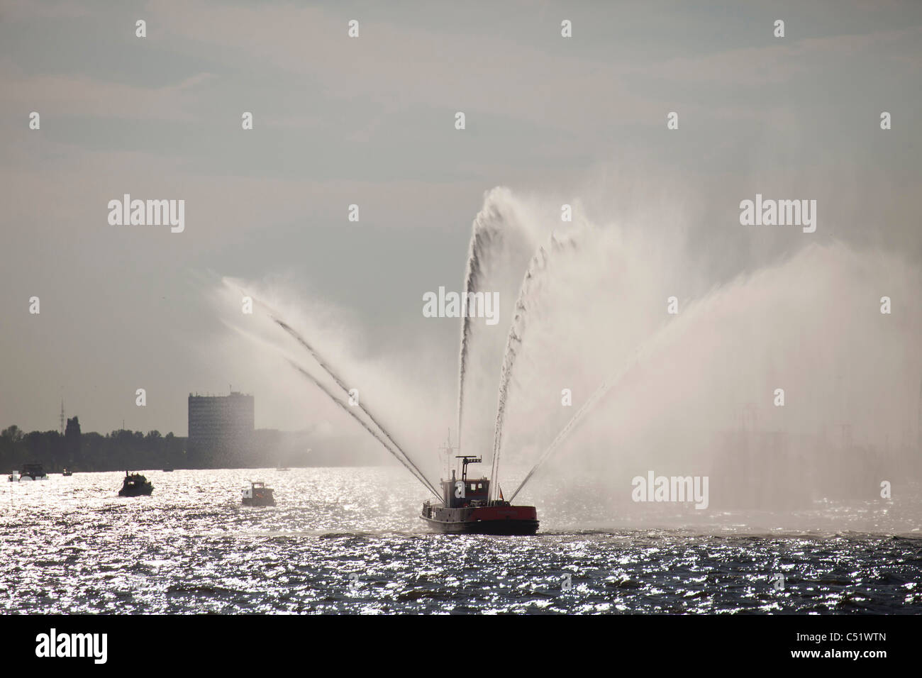 Fire boat spouting water in all directions, Hafengeburtstag or Port ...