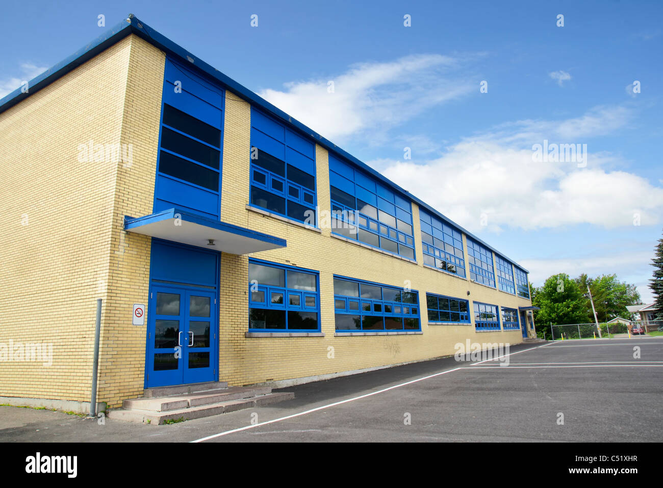 Small local two story high old school building made of yellow bricks ...