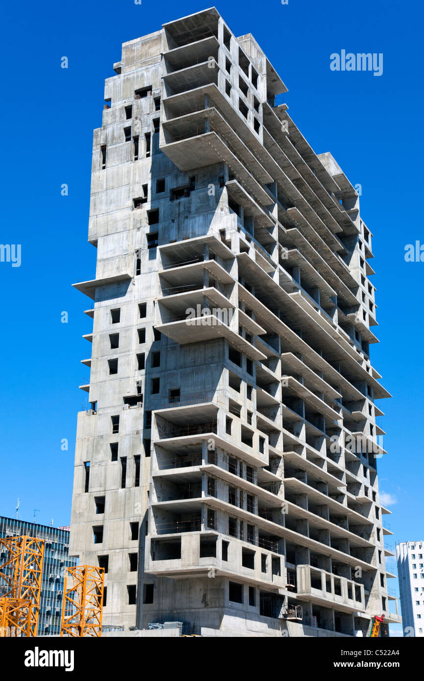 Construction of a monolithic high-rise buildings against the blue sky ...