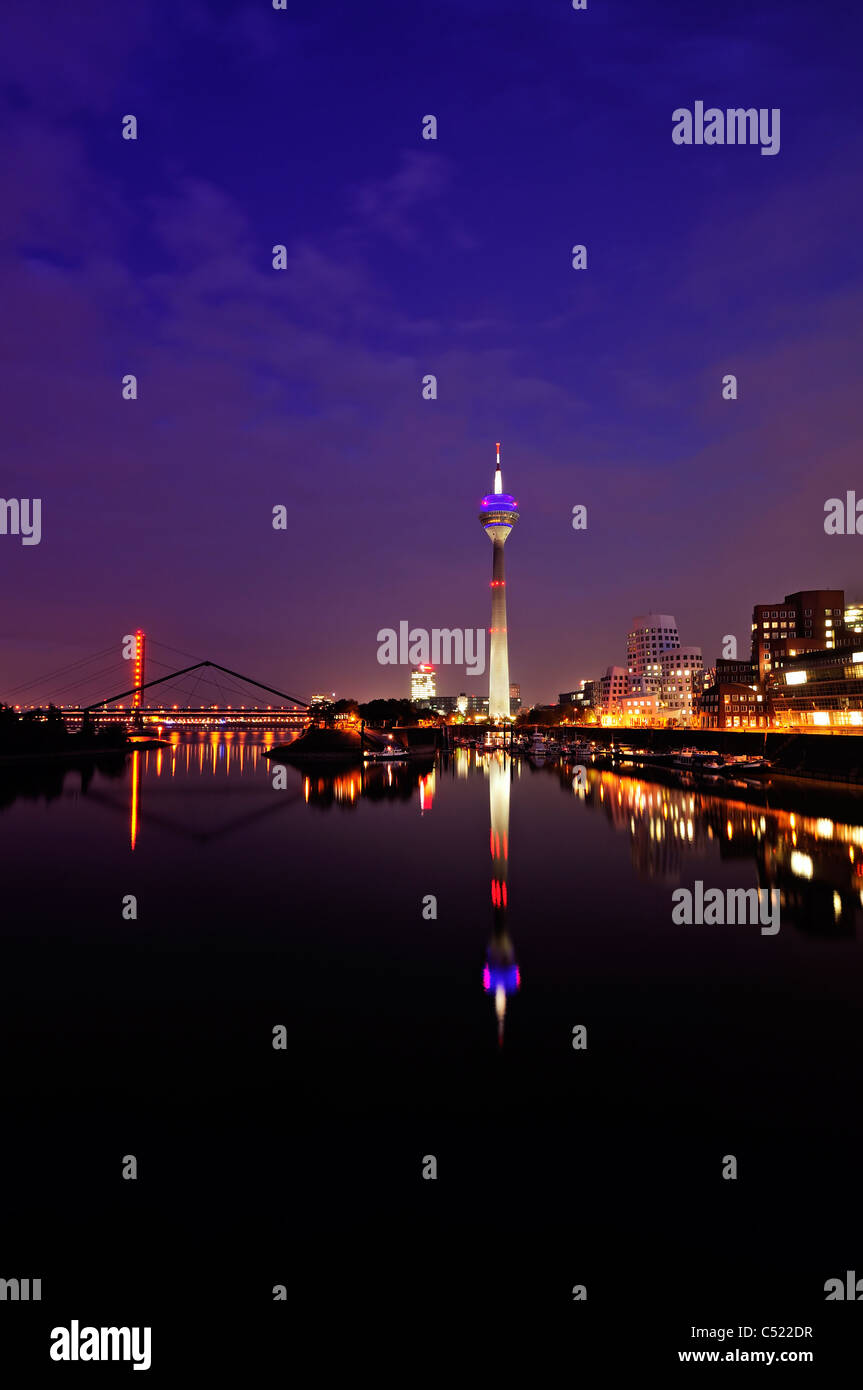 Night scene of media harbour (Medienhafen) with Rheinturm Tower and ...