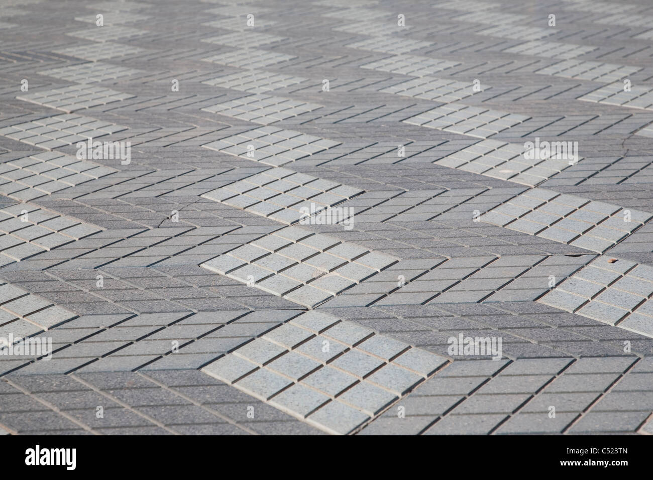 Grey Zig-zag Pavement Pattern in Urban Setting Stock Photo - Alamy