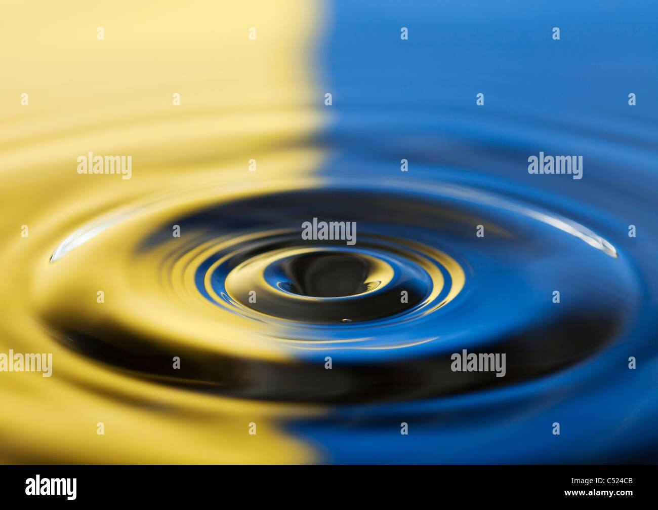 High speed flash image of blue and gold ripples from water drop Stock ...