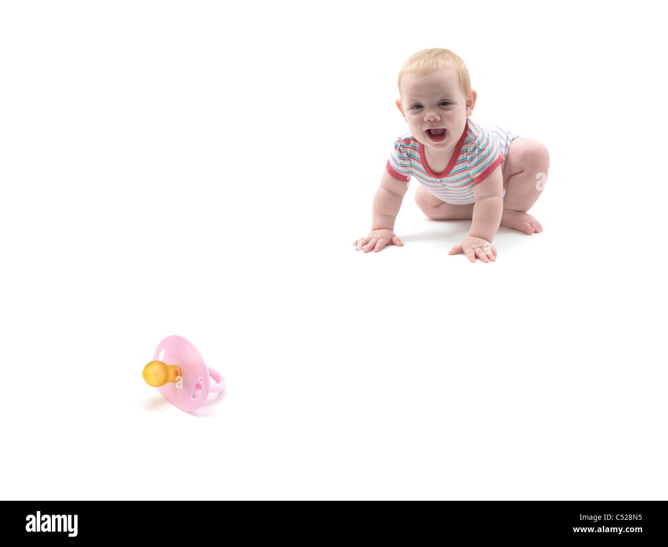 A small baby girl playing by herself Stock Photo - Alamy