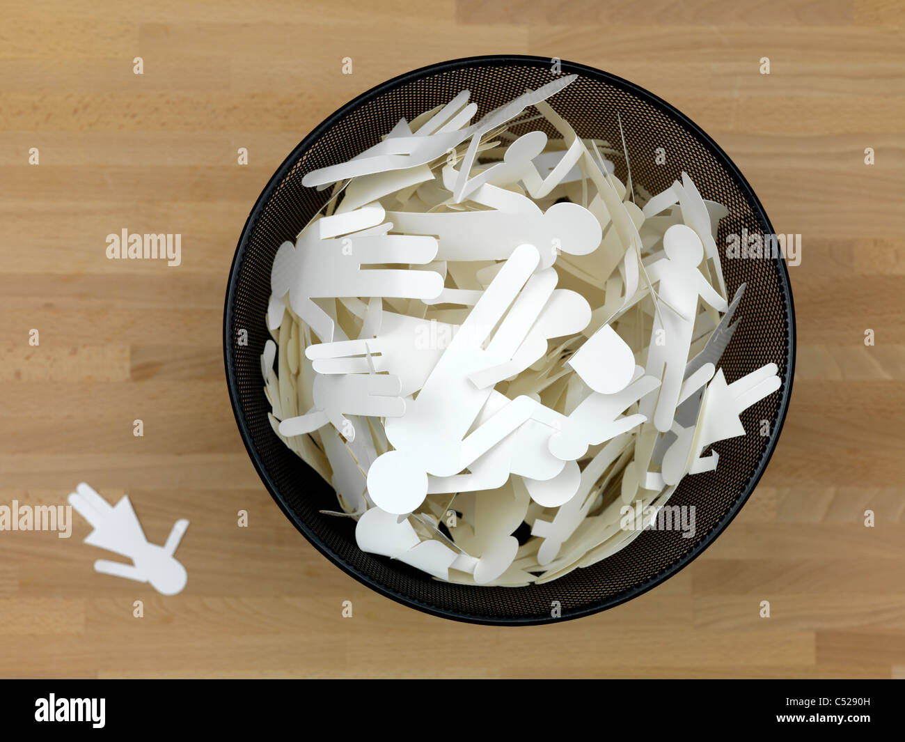 A trash bin with people cutouts isolated on a wooden floor Stock Photo ...