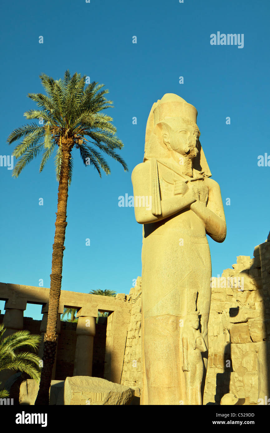 Karnak's granite colossus attribured to Rameses II with one of his ...