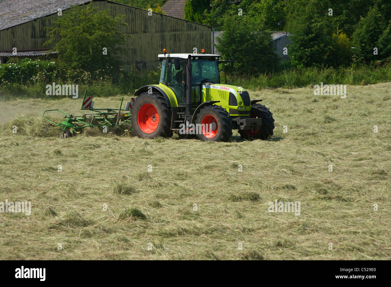 Claas Ares 697 ATZ turning Hay Stock Photo - Alamy
