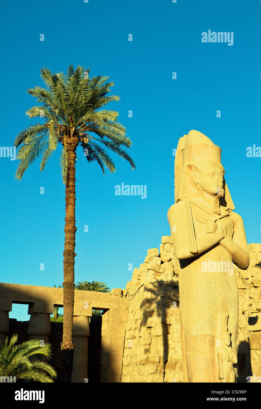 Karnak's granite colossus attribured to Rameses II with one of his ...