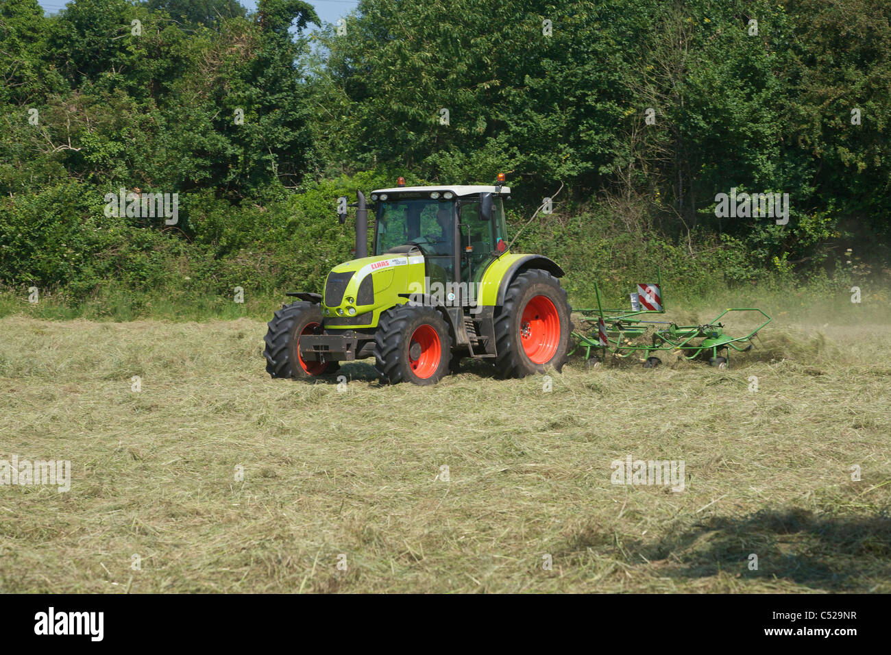 Claas Ares 697 ATZ turning Hay Stock Photo - Alamy