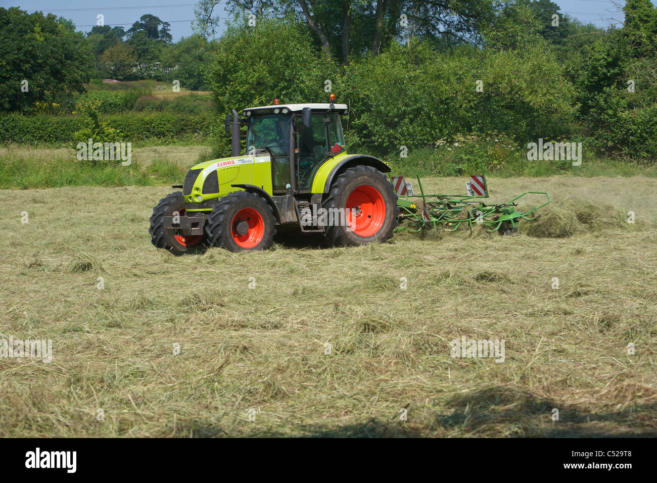 Claas Ares 697 ATZ turning Hay Stock Photo - Alamy