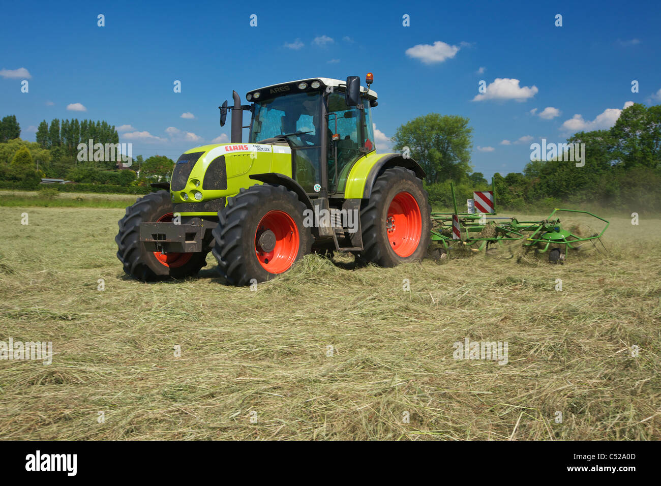 Claas Ares 697 ATZ turning Hay Stock Photo - Alamy
