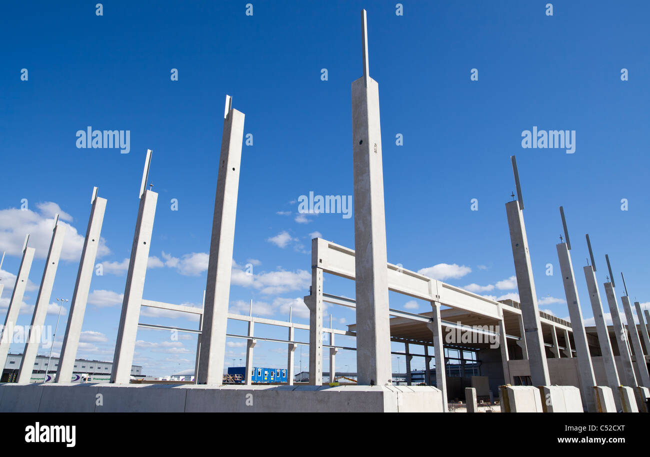 Building frame with erected concrete support pillars at construction ...