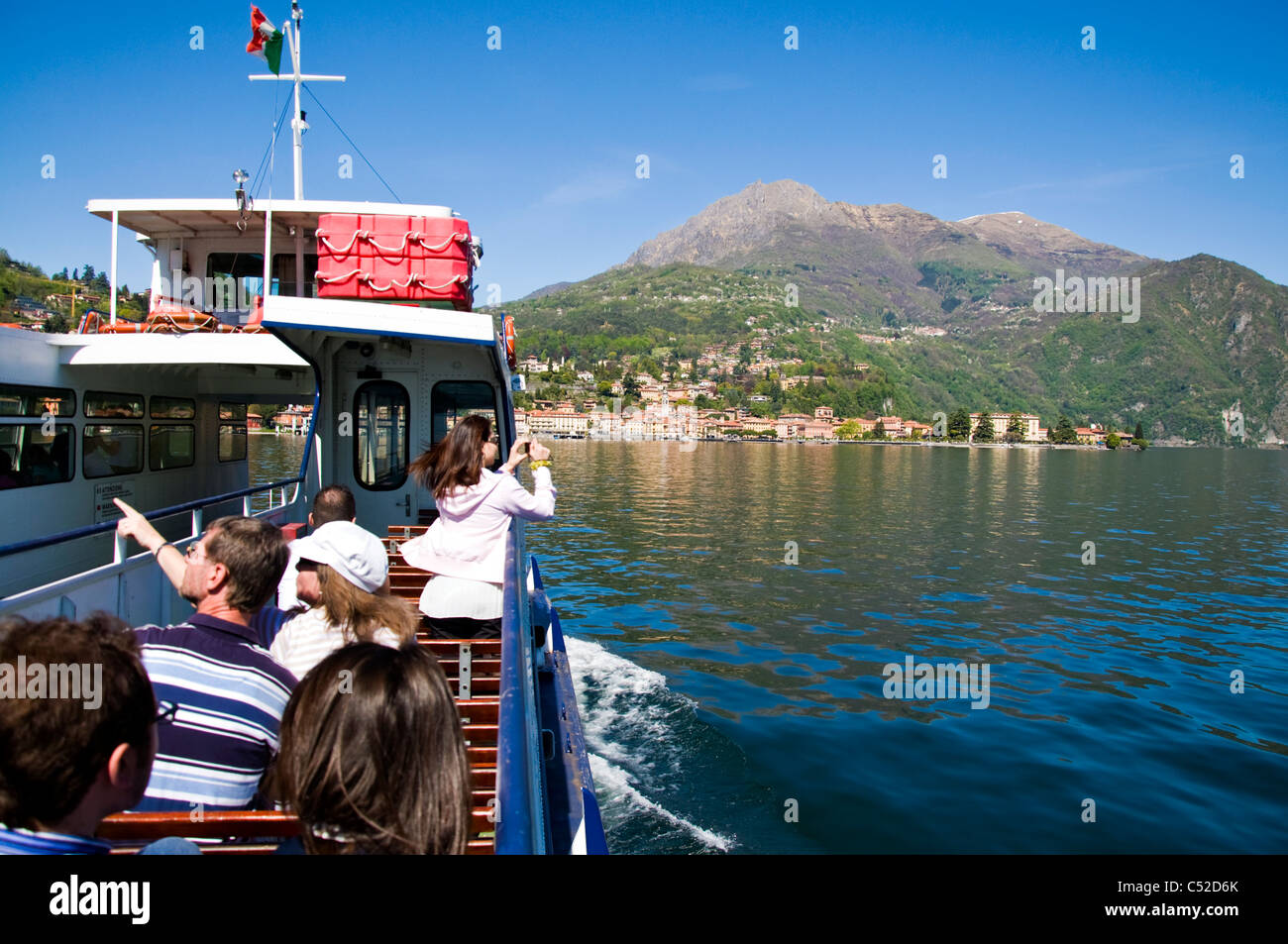 Tourists on a ferry approaching Menaggio on Lake Como Stock Photo - Alamy