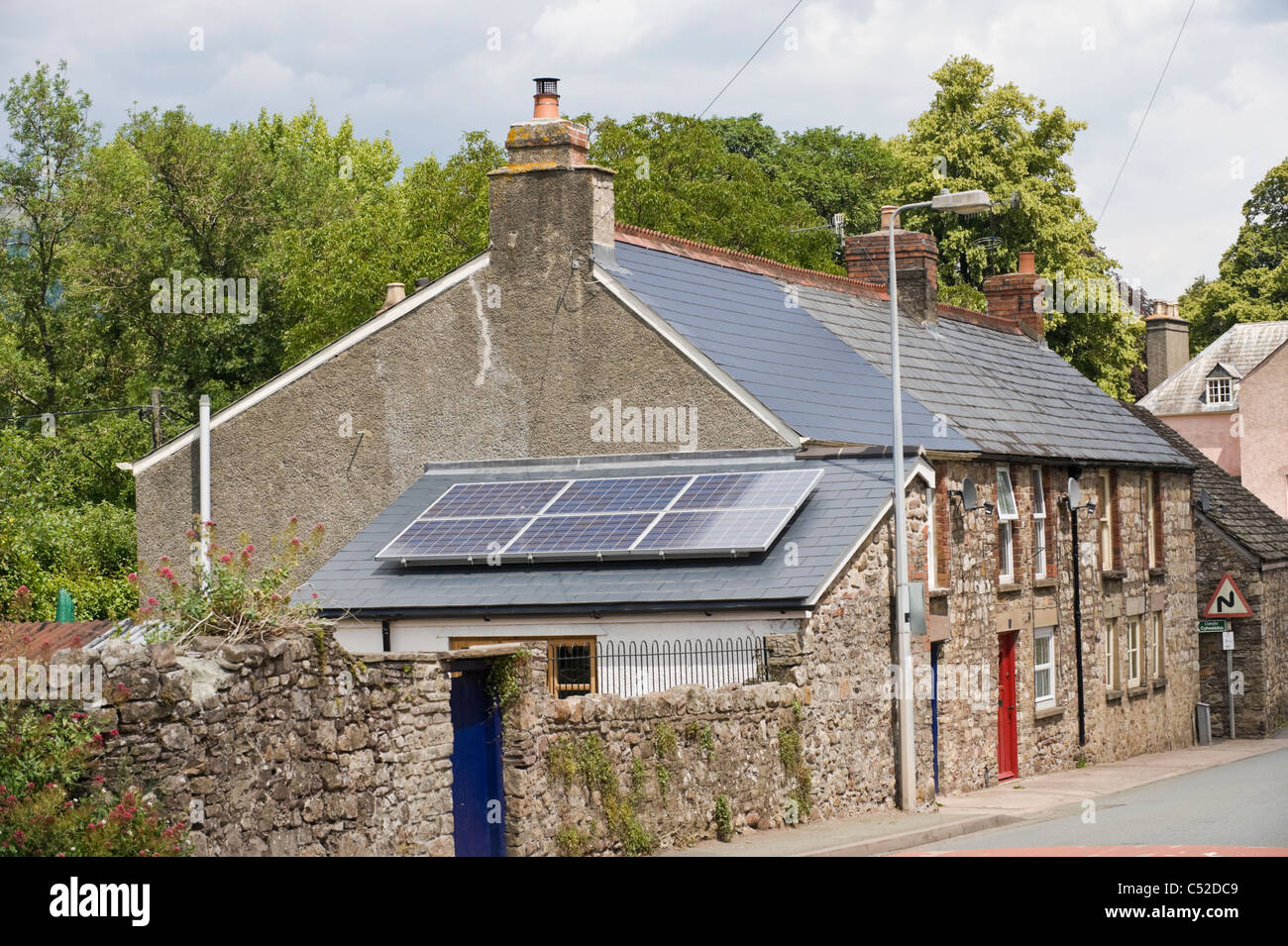 Solar panels on roof of terraced cottage in village of Llangattock ...