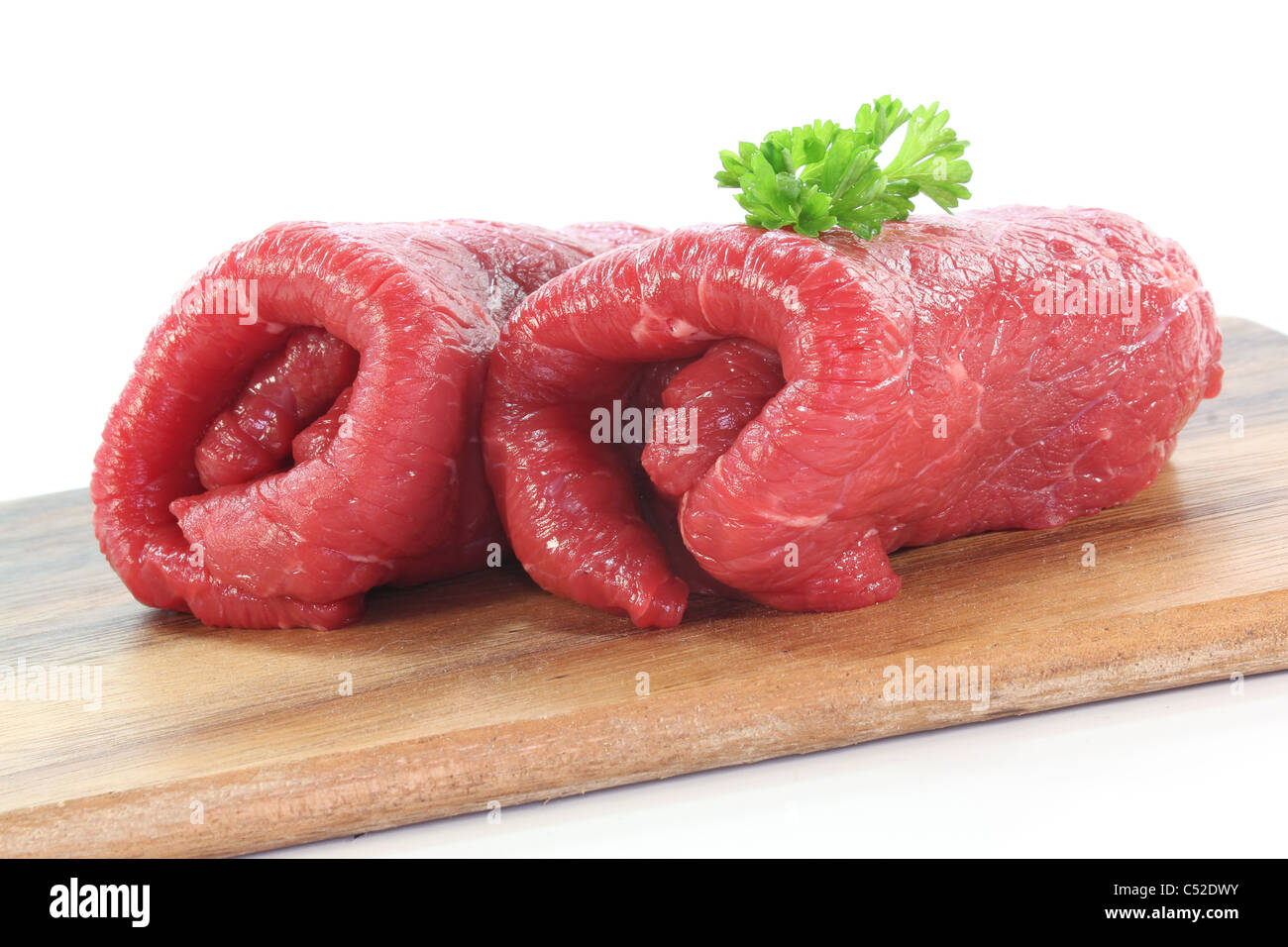 fresh raw beef rolls with parsley on a white background Stock Photo - Alamy
