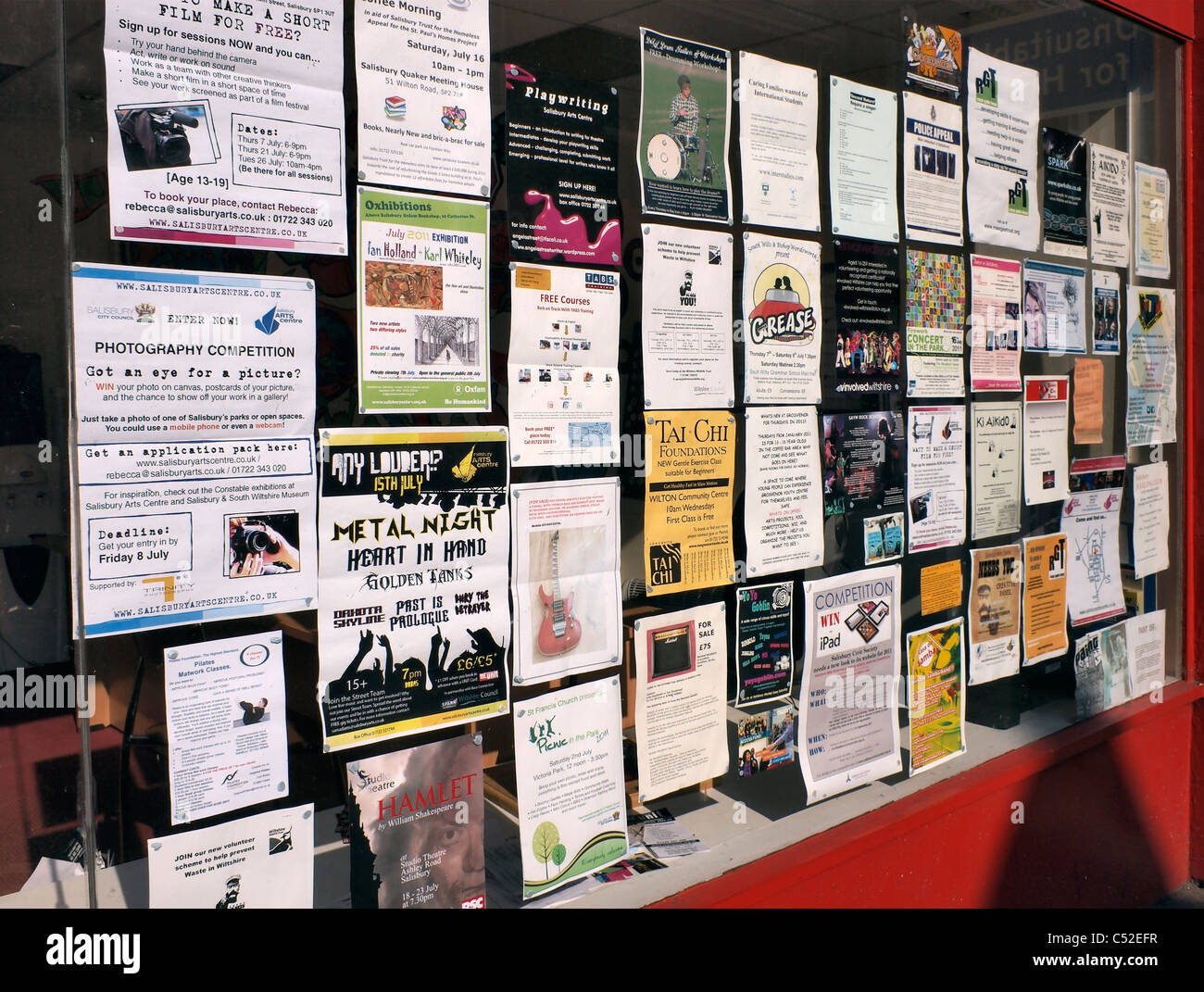 Posters and adverts in shop window Stock Photo - Alamy