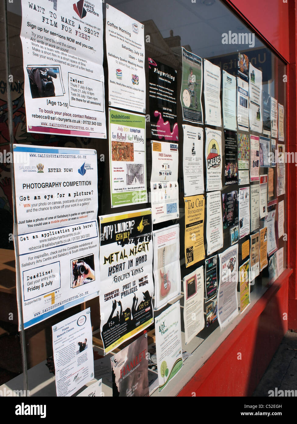 Posters and adverts in shop window Stock Photo - Alamy