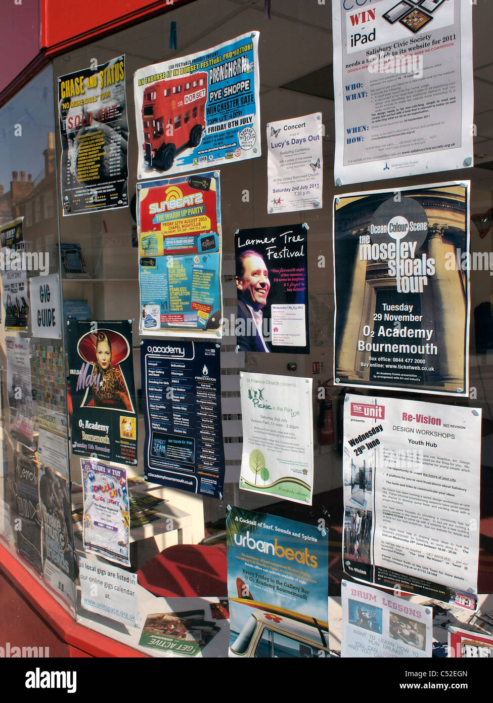 Posters and adverts in shop window Stock Photo - Alamy