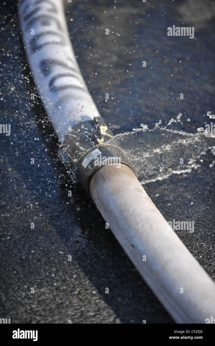 leaking fire hose Stock Photo - Alamy
