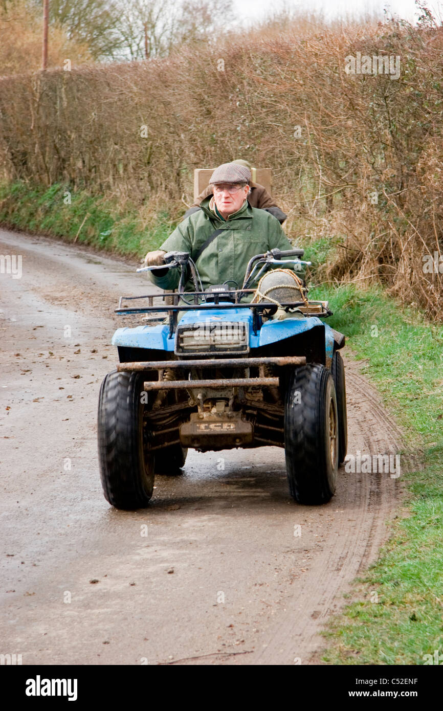 Mature man riding a quad bike, Suffolk, England Stock Photo - Alamy