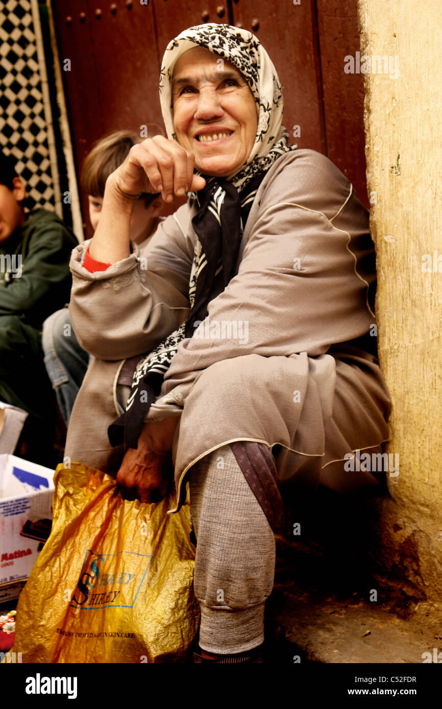 Woman sits with kids in Medina Stock Photo - Alamy