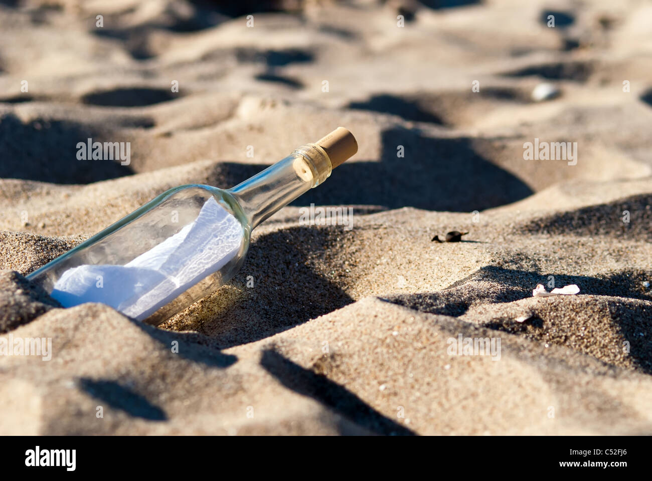 a message in a bottle lies in the sand on the beach Stock Photo - Alamy