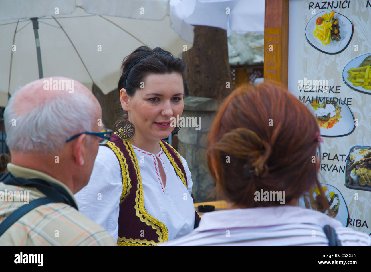 Hostess showing and promoting the foods of her restaurant Mostar city ...