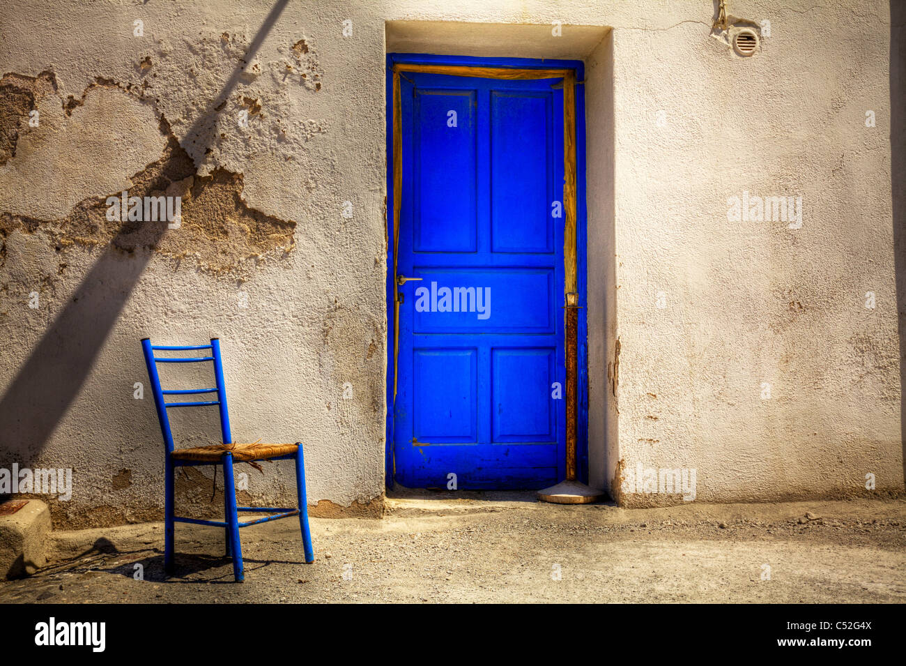 Thira on iconic Greek island of Santorini, typical Greece, blue chair ...