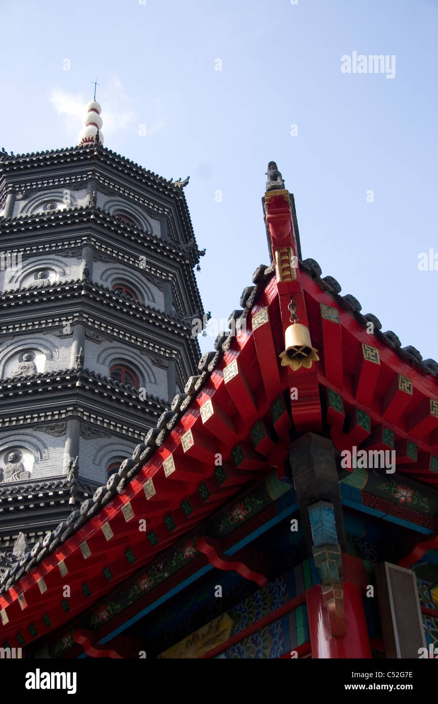 Ornate roof with gold hanging lantern and pagoda at Jile Temple, Harbin ...