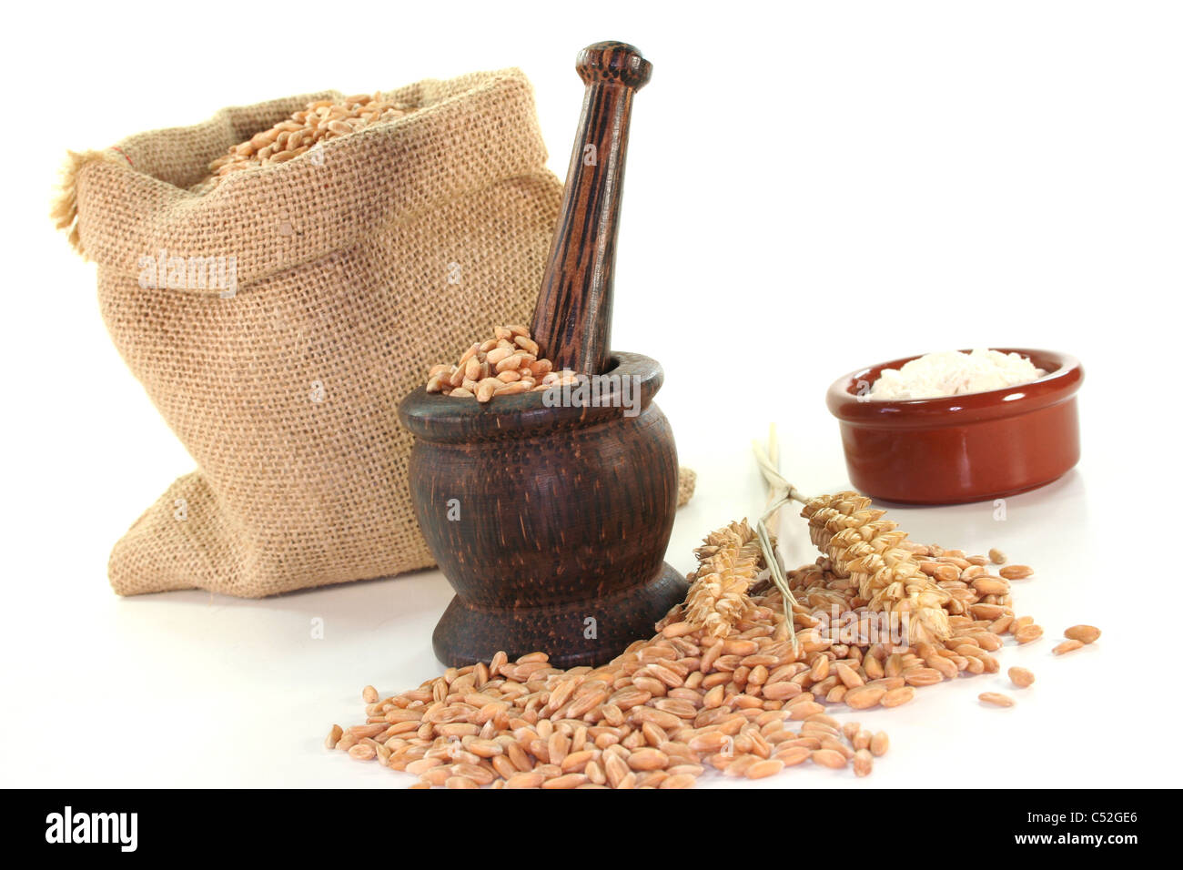 Sack of grain with mortar, flour and wheat ears on a white background ...
