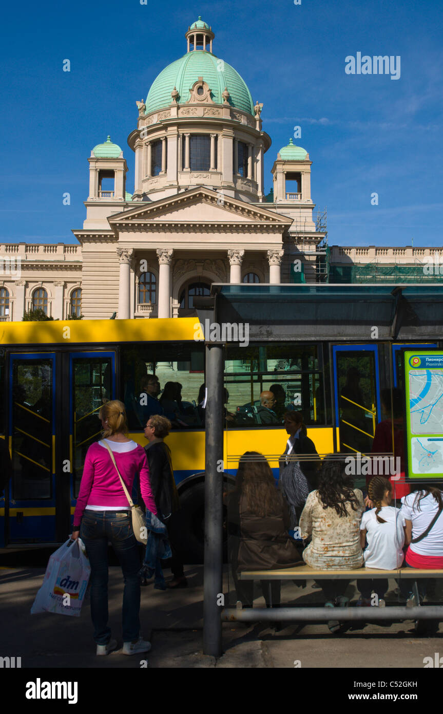 People at bus stop in Pionirski Park across from Serbian Parliament ...