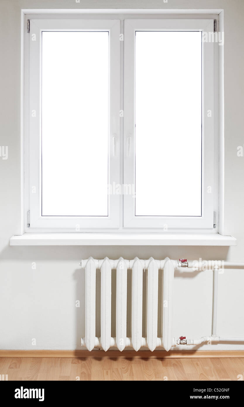 White plastic double door window with radiator under it. Domestic room ...