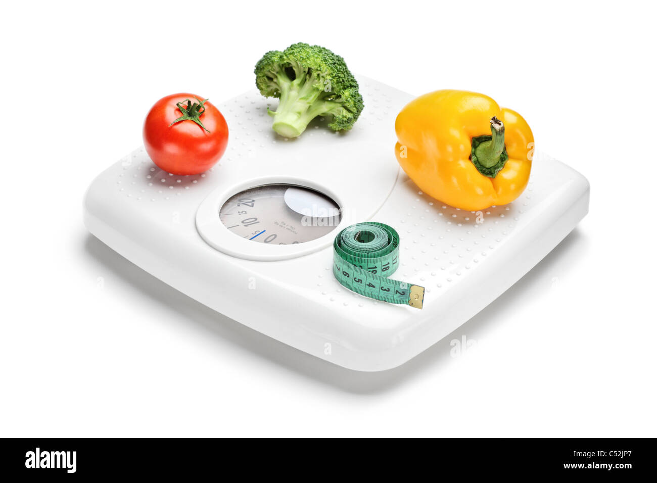 Vegetables and measuring tape on a weight scale Stock Photo - Alamy
