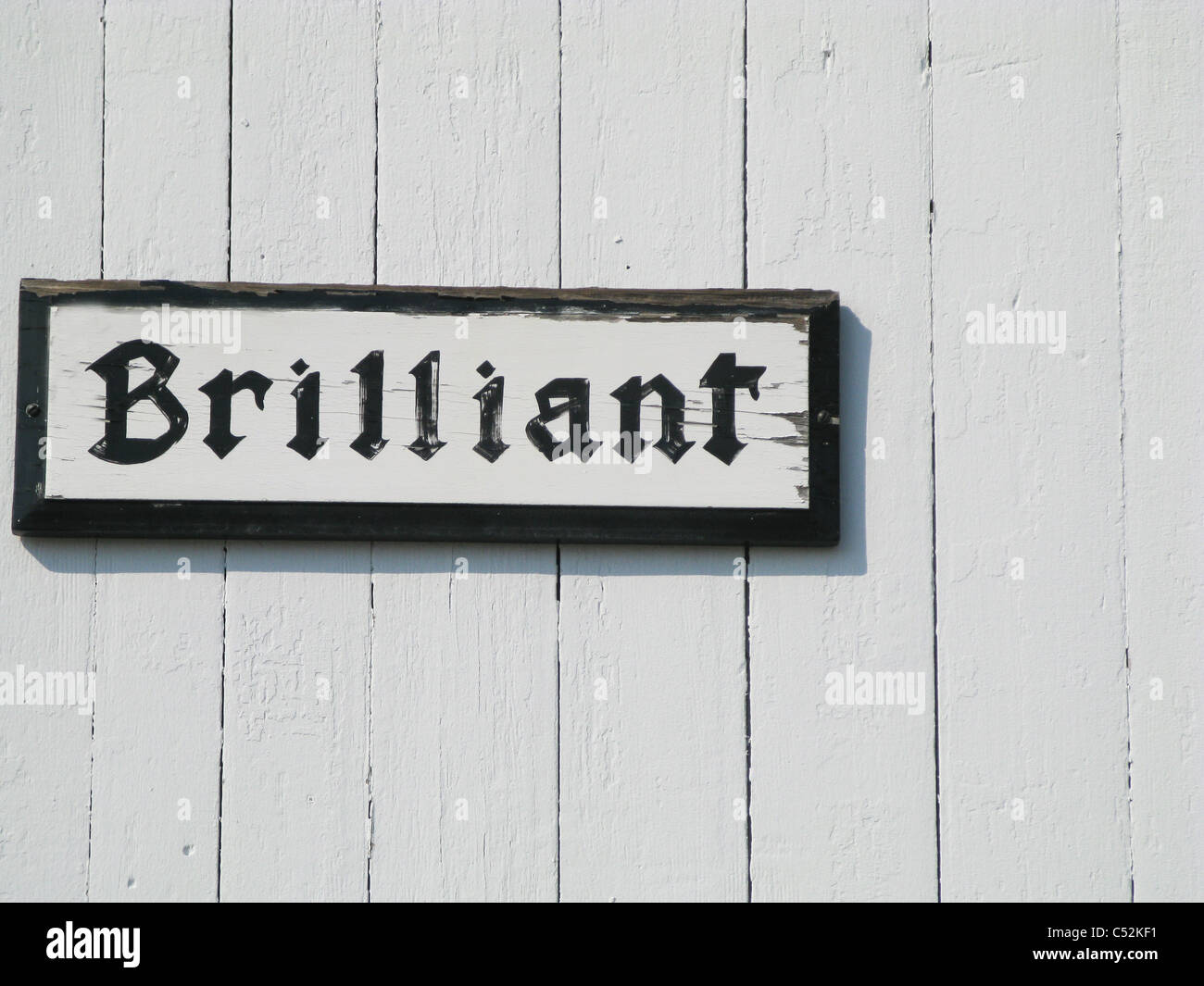 Brilliant sign on wood wall Stock Photo - Alamy