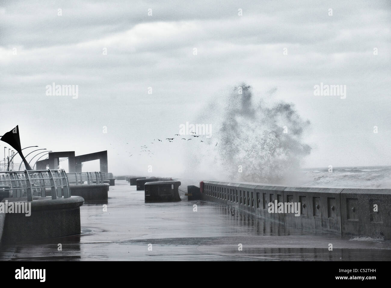 waves crashing on to sea defence wall Stock Photo - Alamy