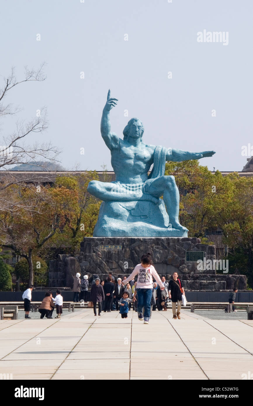 Young girl walking in front of the Nagasaki Peace Statue, Peace Park ...