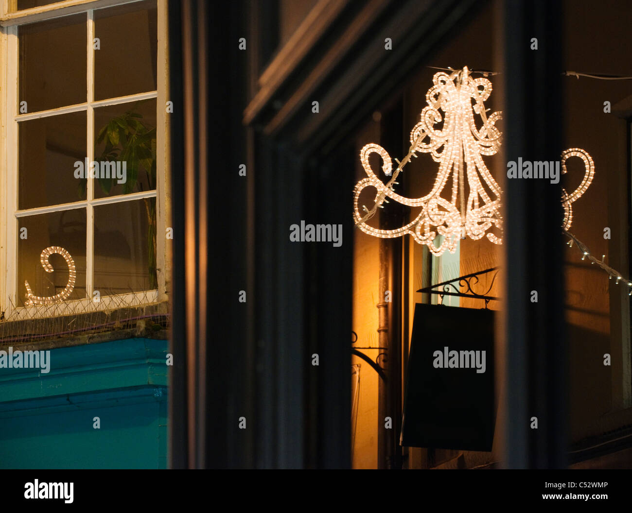 Christmas lights reflected in shop window Stock Photo - Alamy