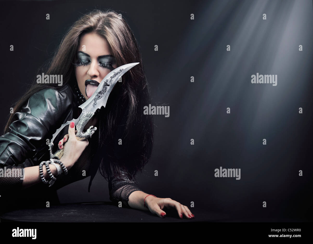 Attractive young woman with knife Stock Photo - Alamy