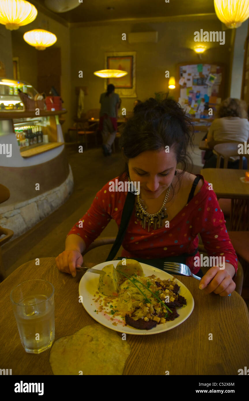 Woman eating a plateful of veggie versions of Czech foods Maitrea ...