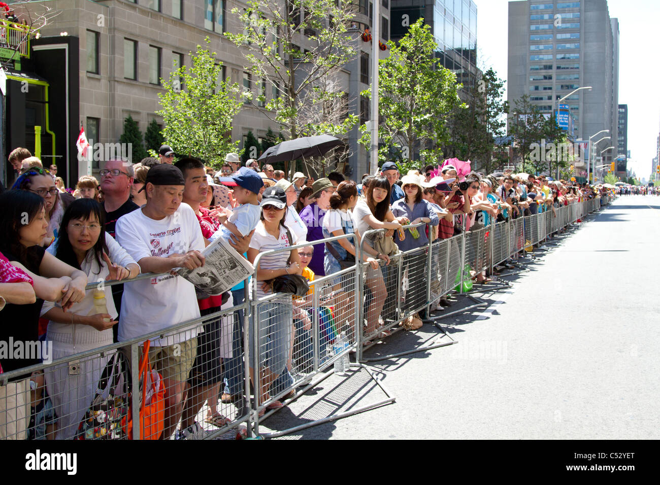 crowd people waiting behind fence outdoor parade Stock Photo - Alamy