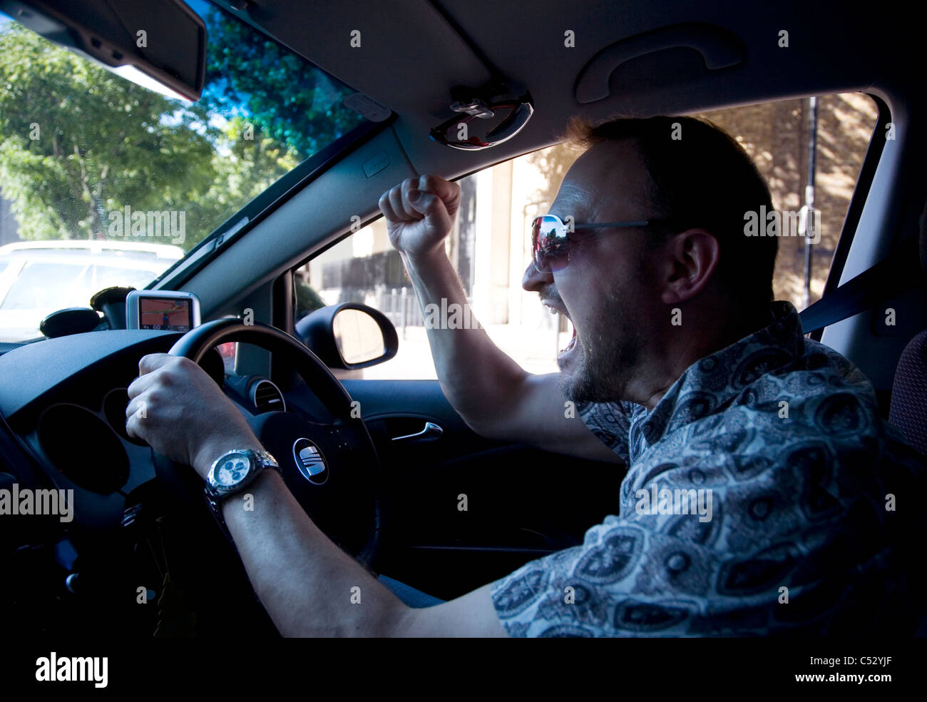 Man driving car - road rage Stock Photo - Alamy