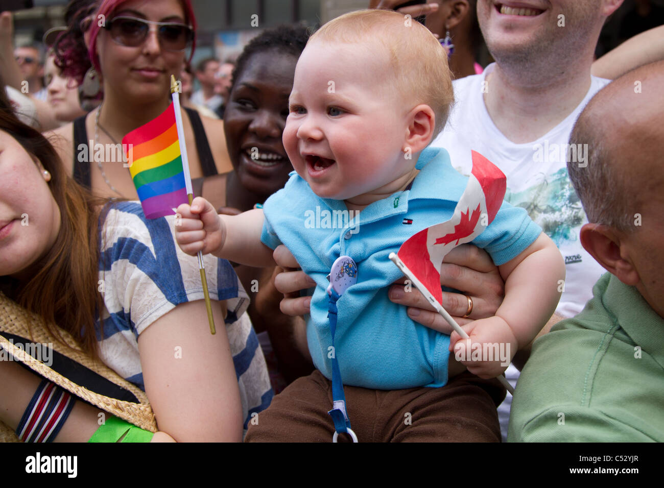 young white baby excited outdoor street crowd Stock Photo - Alamy