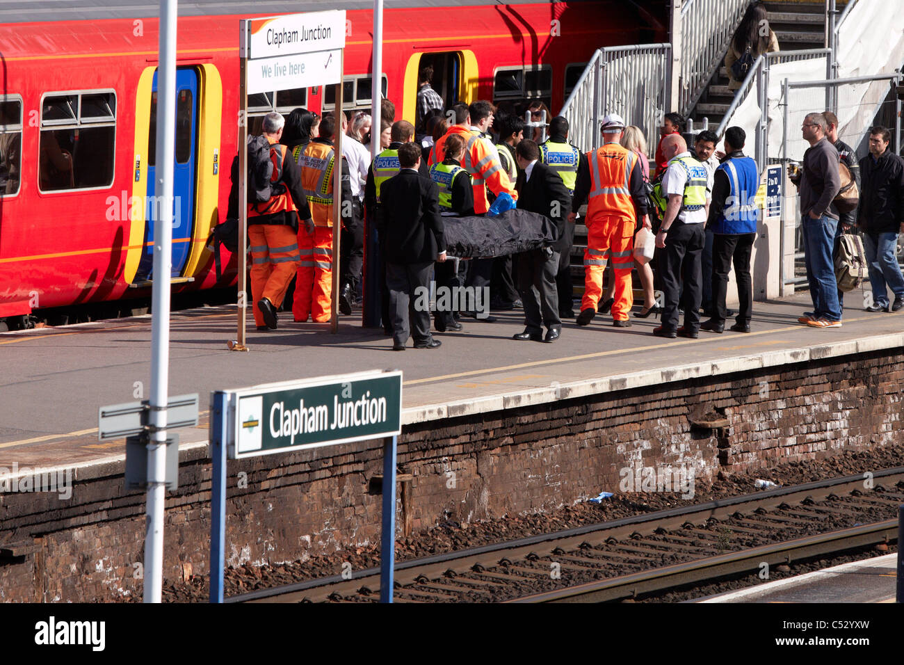 Undertakers recover the body of a suicide victim hit by a train at ...