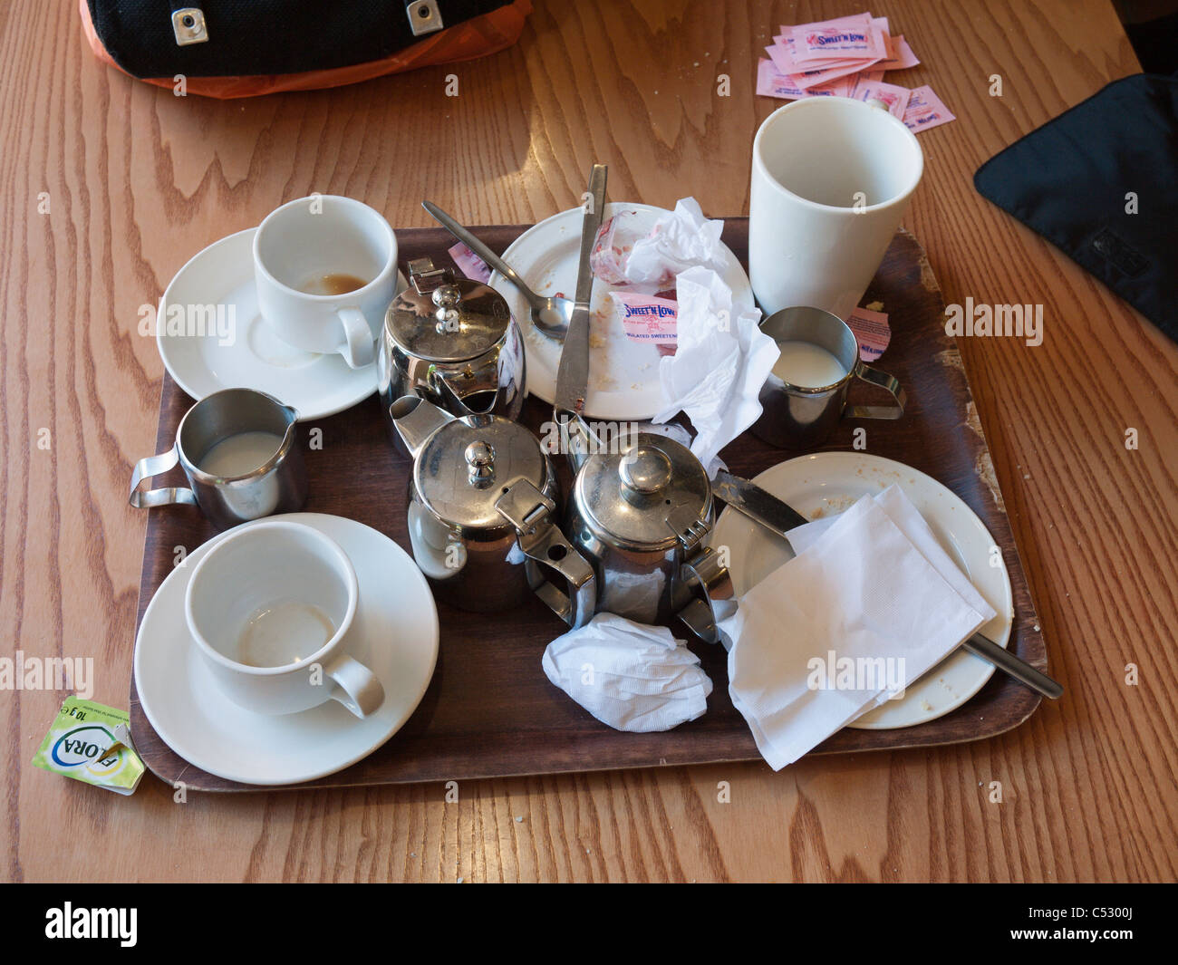 cafe tray on table with cups saucers, tea pots, sweeteners and milk ...