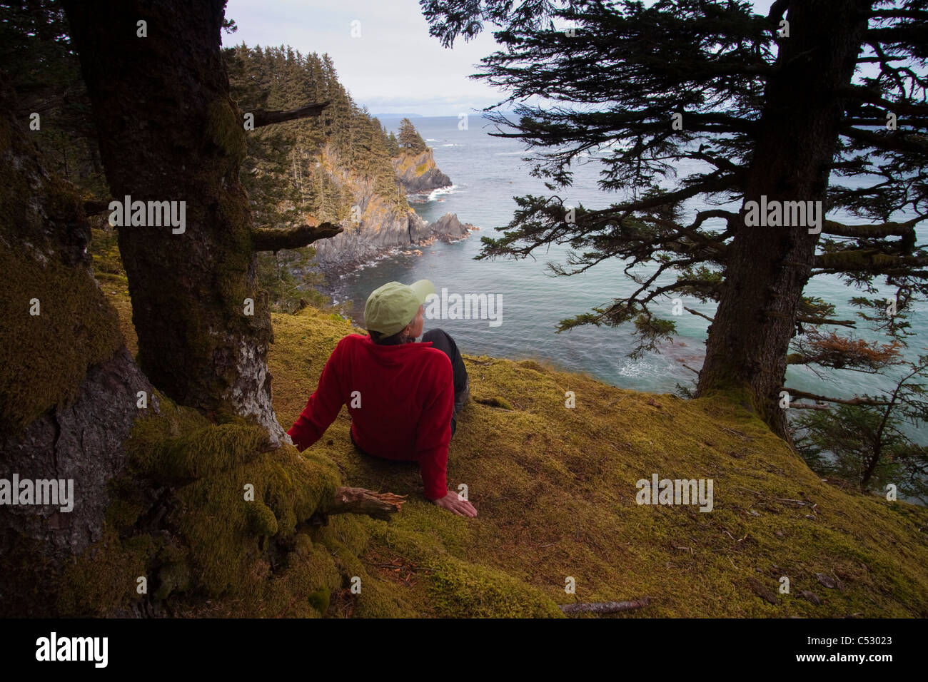 Female hiker resting, Chiniak Bay at Fort Abercrombie State Historical ...