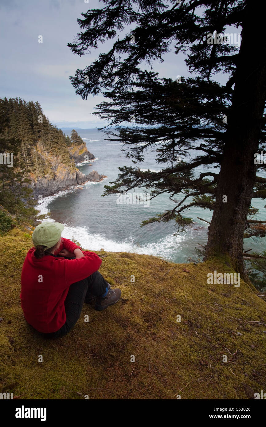 Female hiker resting, Chiniak Bay at Fort Abercrombie State Historical ...