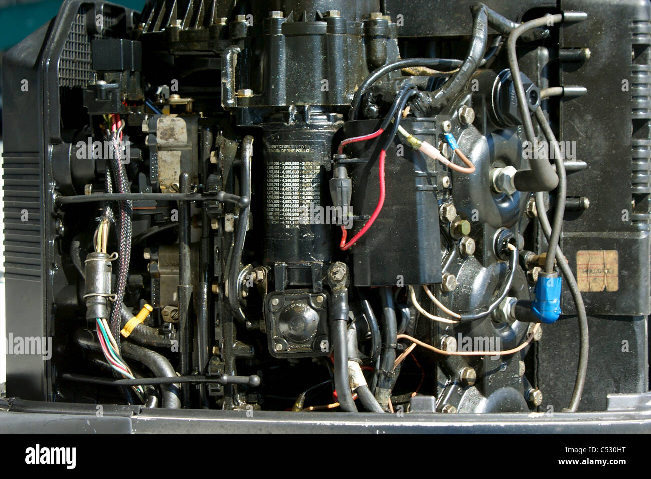 The top part of an outboard motor is opened up and exposed for repair ...