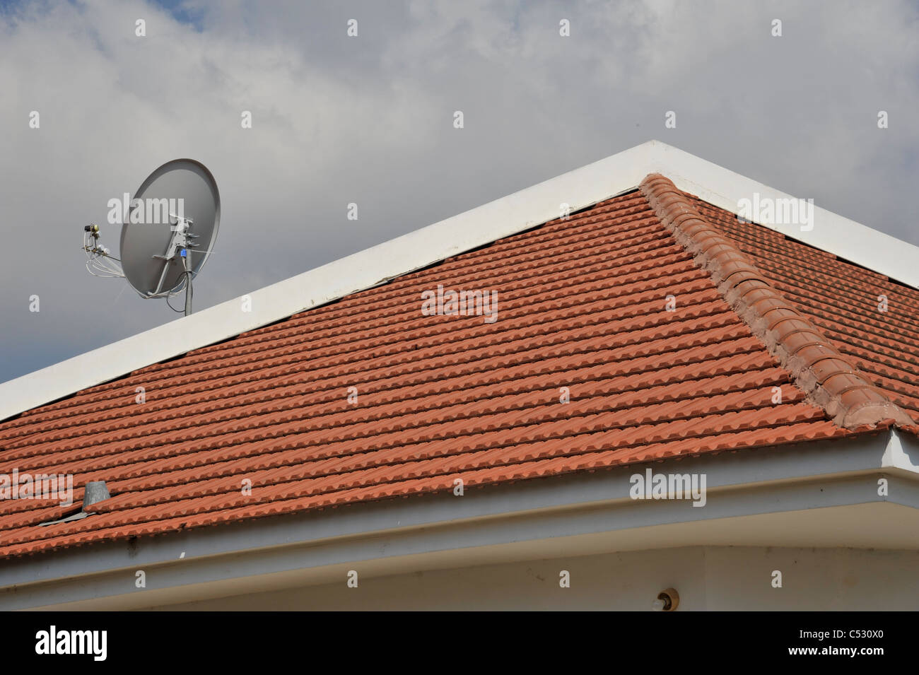 roof of a house with a satellite dish Stock Photo - Alamy